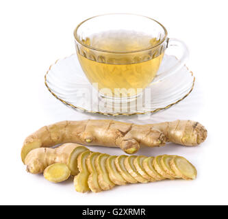 Glass cup of black tea, ginger roots, anise and cinnamon on wooden ...