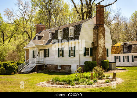 An 18th century colonial American farmstead with various out buildings ...