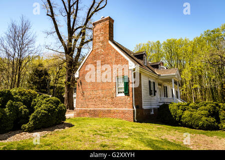 An 18th century colonial American farmstead with various out buildings ...
