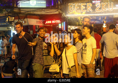Friends doing selfie stick fun posing pose Vietnamese Stock Photo - Alamy