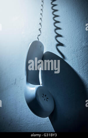 Telephone receiver left hanging Stock Photo - Alamy