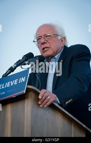 Bernie Sanders holding a speech at a rally in San Diego, surrounded by ...