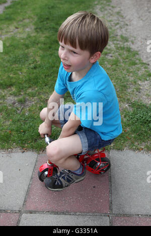 Small boy riding bicycle outside child rides bike wearing helmet Stock ...