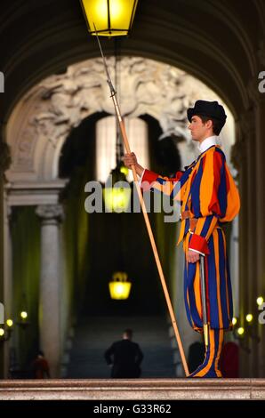 A Pontifical Swiss guard armed with a halberd standing outside St Peter ...