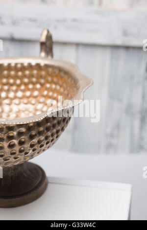 Ancient metalic bowl on table Stock Photo - Alamy