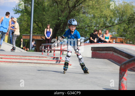 Feet of rollerblader in aggressive inline skates grinding a rail in ...