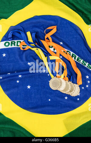 Gold medals on brazilian flag Stock Photo - Alamy
