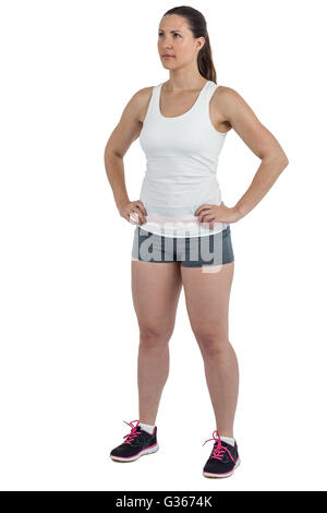 Woman standing with hands on her hips Stock Photo - Alamy