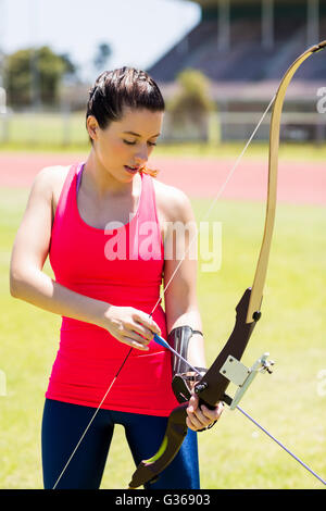 Female athlete practicing archery Stock Photo - Alamy