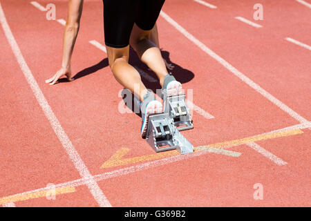 Female athlete in ready to run position Stock Photo - Alamy