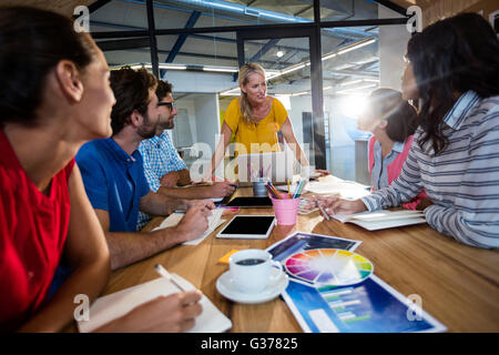 business team with tablet pc having discussion Stock Photo - Alamy