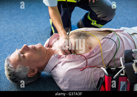 Senior woman heart attack patient being monitored in Resuscitation ...