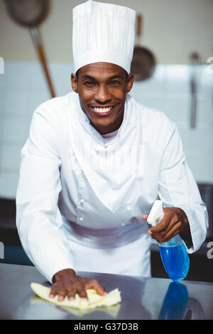 Smiling man cleaning counter with rag in coffee shop Stock Photo - Alamy