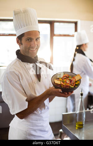Happy smiling chef garnish a salad Stock Photo - Alamy