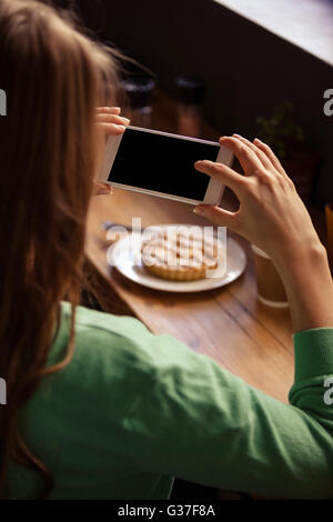 Photo over the shoulder of the woman sitting in front of laptop and ...