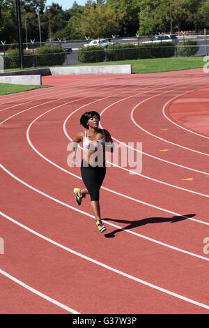 Young plump Black woman running on track outdoors Stock Photo - Alamy