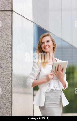 Beautiful woman using electronic tab in the street Stock Photo - Alamy