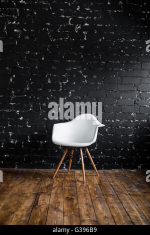 Modern grey chair with white brick walls on background and wood floor ...