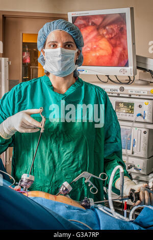 Surgeon performs minimally invasive laparoscopic abdominal surgery, as ...