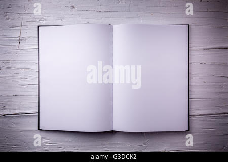 A closeup shot of an open blank book with a pencil cup isolated on ...