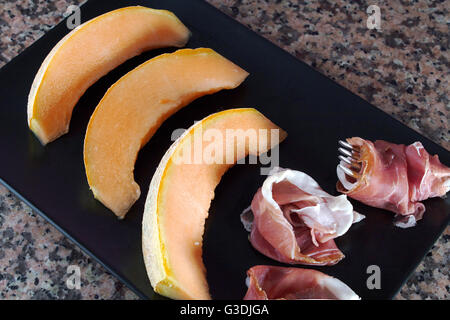 Slices of fresh melon with roses of Parma Italian ham, as typical ...