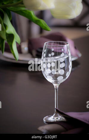 Shallow focus beautiful table setting with crockery and glasses for an ...