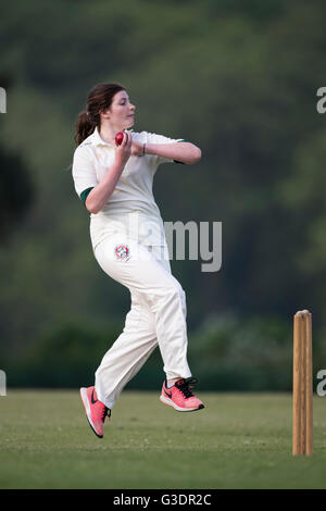 Female cricketer bowling Stock Photo - Alamy