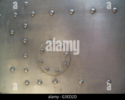 Old metal plate sign with rivets on steel background. With copy space ...