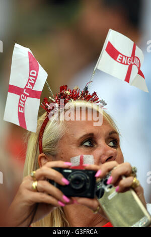 A fan wears flags in her hair beefore the World Cup Group G soccer ...