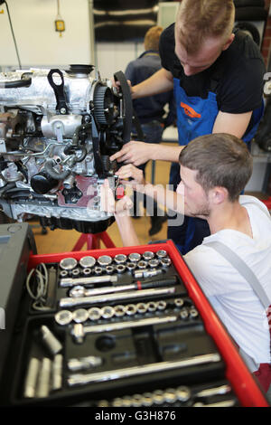 Automotive mechatronics engineer trainees work on a car at the Stock ...