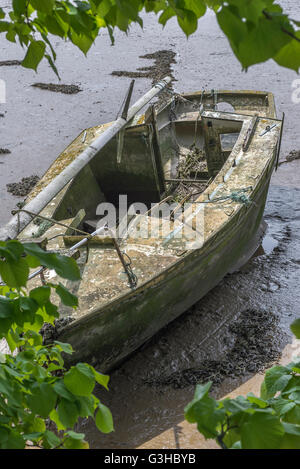 Sinking boat concept. Boat as a visual metaphor for washed up, beached ...
