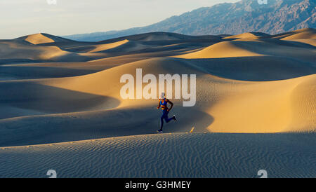 Runner sprinting in desert, Death Valley, California, USA Stock Photo ...
