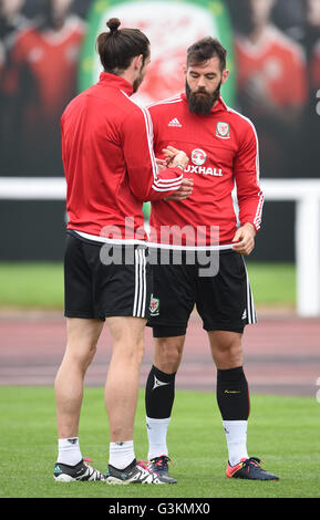 Wales' Gareth Bale (left) offers Joe Ledley a hairband for his beard ...