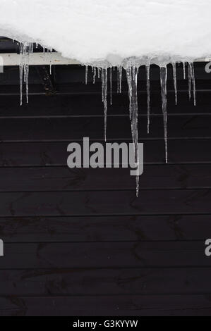 Icicles hanging from roof, Sweden Stock Photo - Alamy