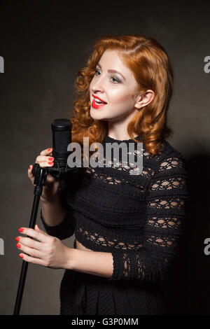 Red-haired diva singing song Stock Photo - Alamy