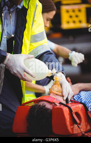 team of emergency medical staff rescuing patient Stock Photo - Alamy