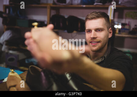 Cobbler holding a shoe tree Stock Photo - Alamy