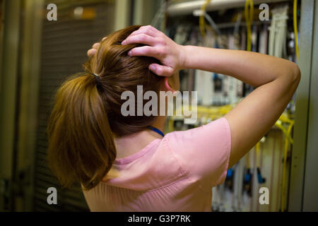 Stressed technician working on broken server Stock Photo - Alamy