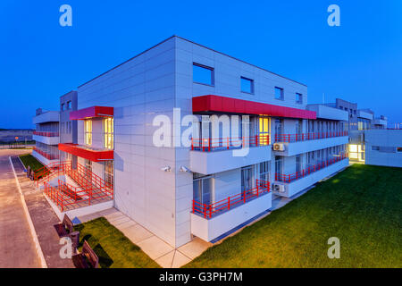 Aerial photo of gray and red facade on modern residential building made ...