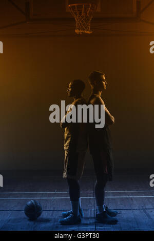 Basketball players posing back to back Stock Photo - Alamy