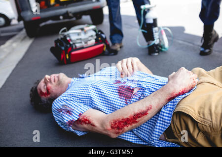 Injured people lying on the ground Stock Photo - Alamy