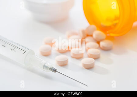 A closeup of pills and syringe with needle Stock Photo - Alamy