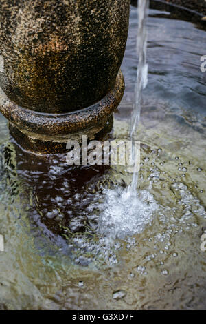Splashed water drops in a stone standpipe Stock Photo - Alamy
