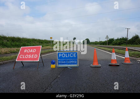 Police Road Closed sign and cones blocking the carriageway during a ...