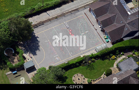 aerial view of a Primary school with supervised children crossing the ...