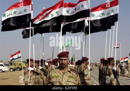 Army soldiers standing in formation with their rifles at a military ...
