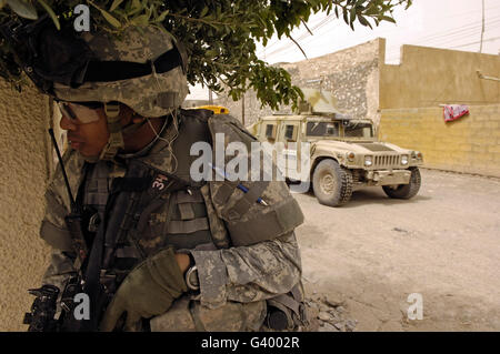 A U.S. Army soldier and an Iraqi police officer conduct a key leader ...