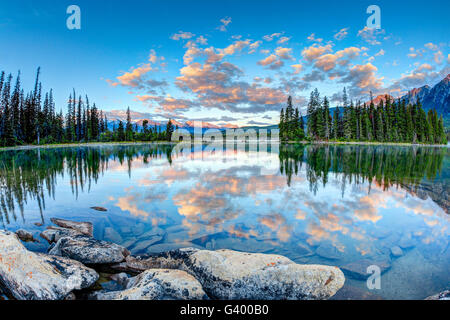 First glimpse of golden sunrise at Pyramid Lake in Jasper National Park ...
