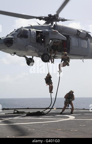 An SH-60 Sea Hawk from HS-14 hovers over USS Kitty Hawk (CV 63) flight ...