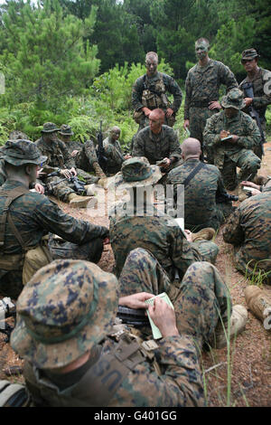 A US Marine Corps Platoon Commander low crawls through the water during ...